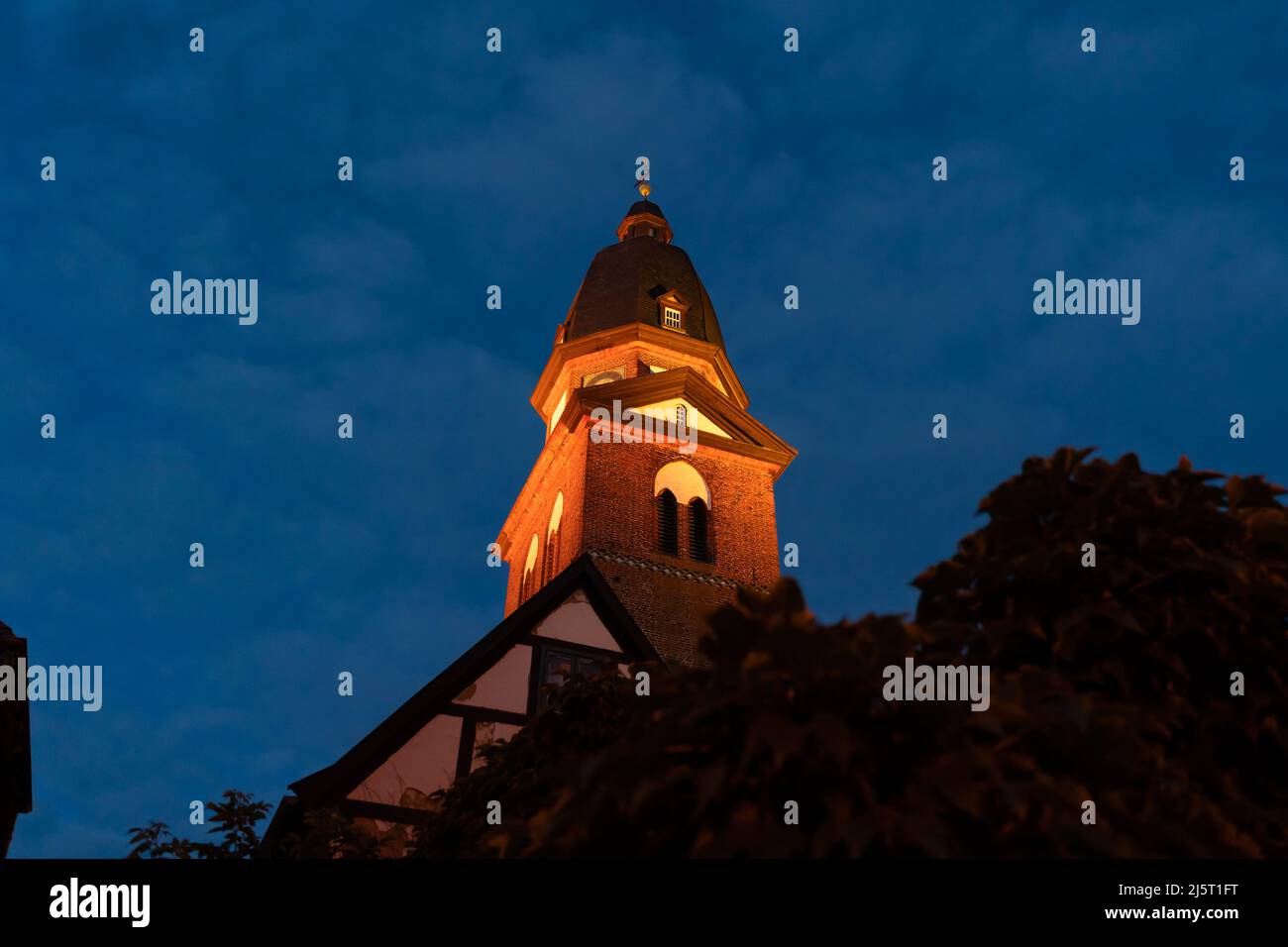 Tower of the church in the city. A beautiful lit building in the ...