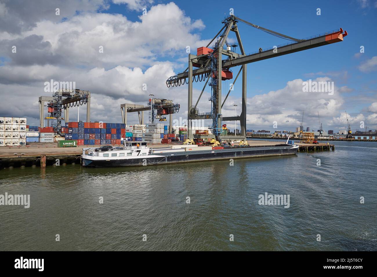 Loading containers on a ship Stock Photo - Alamy