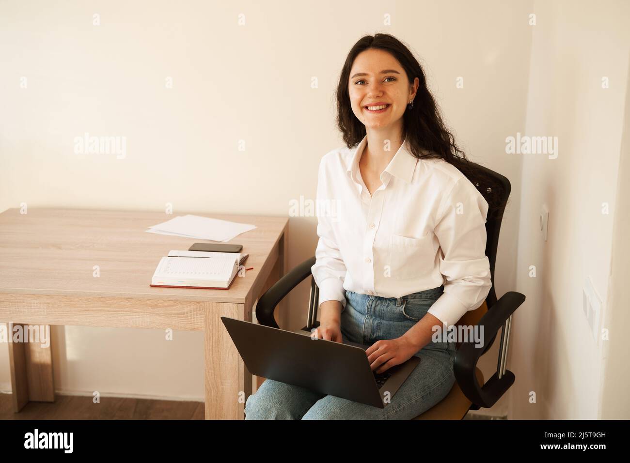 Portrait of girl student studying online using laptop on lap at home ...