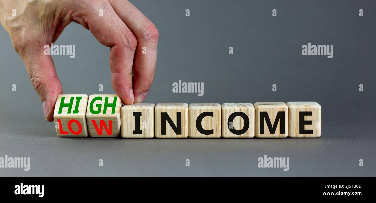 Low or high income symbol. Businessman turns wooden cubes and changes ...