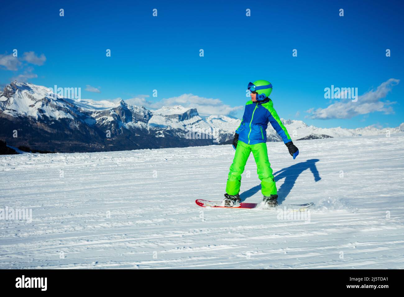 Boy snowboard slide on Alps mountain slope with background Stock Photo ...