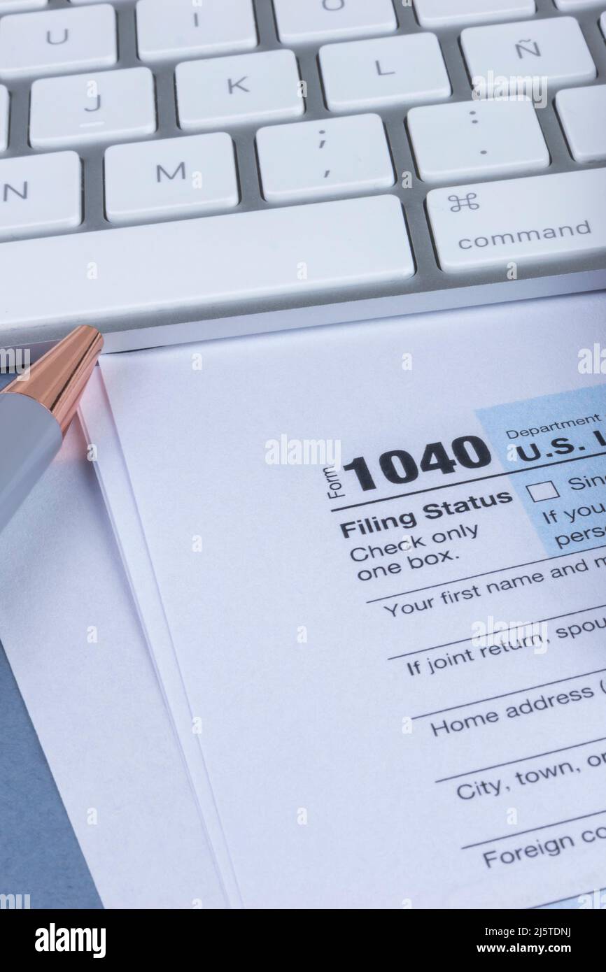 Form 1040 U.S. Individual Income Tax Return on paper with white ...