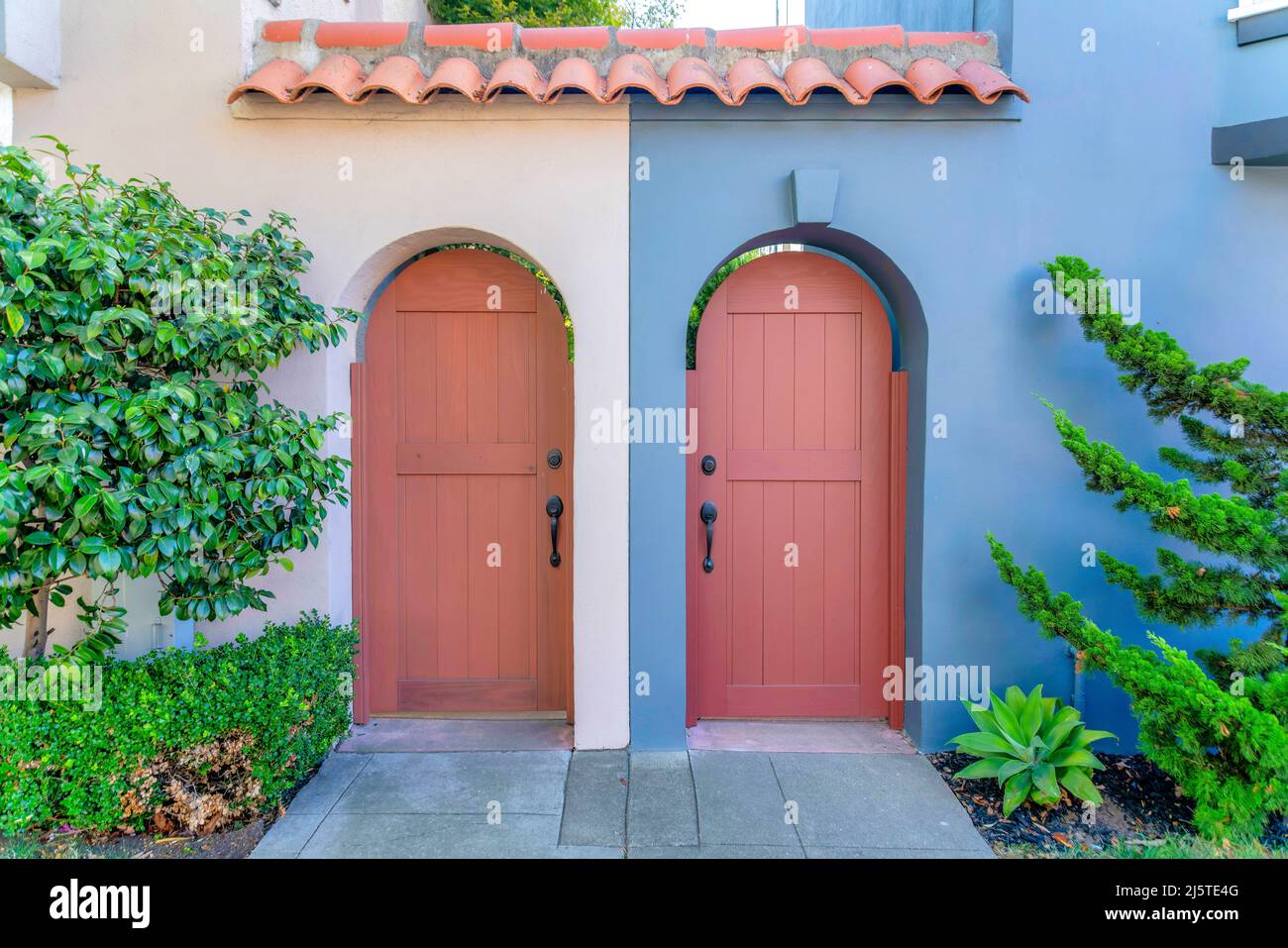 Two neighborhood arched gate doors with concrete entrance in San ...
