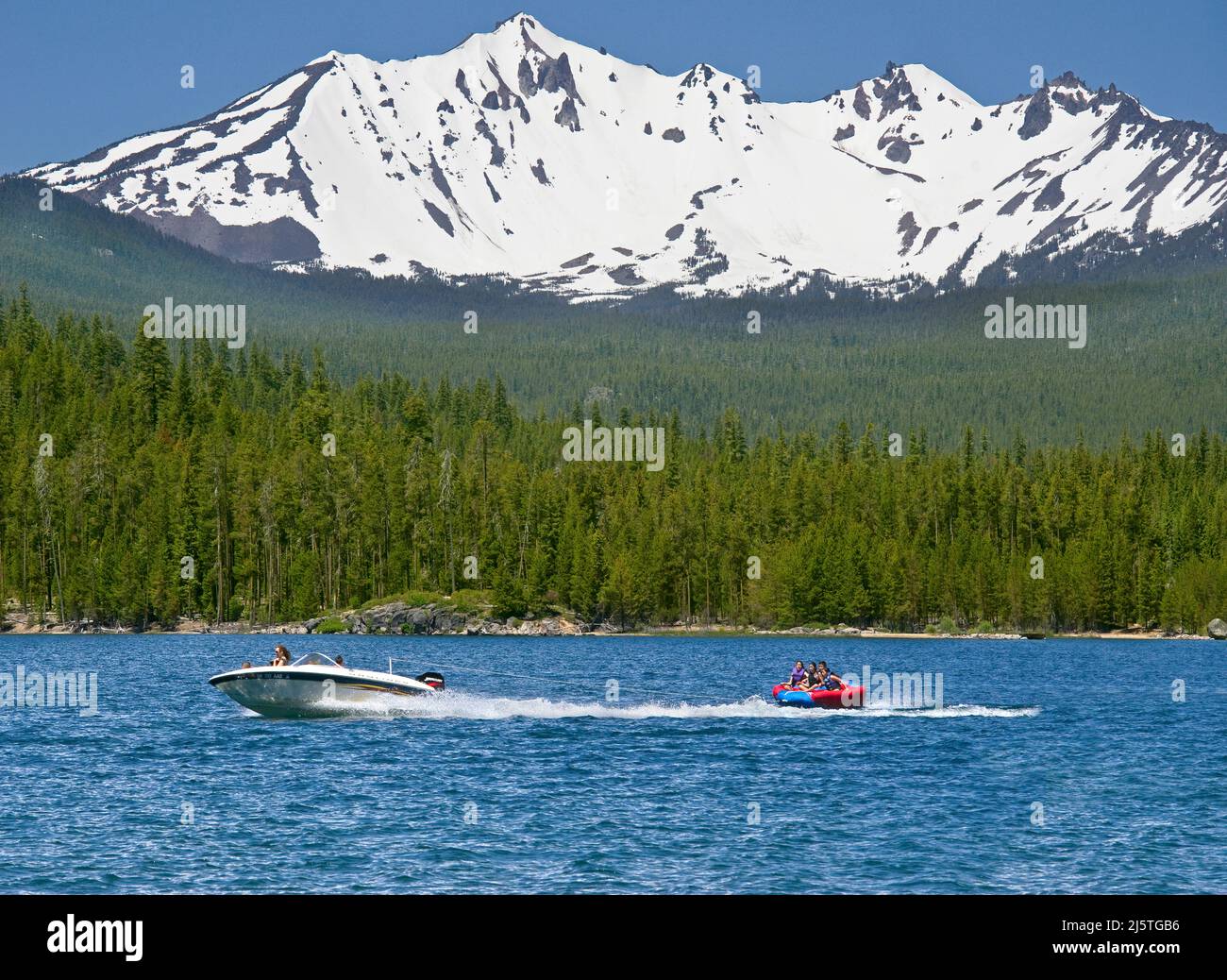 Boating Crescent Lake below Diamond Peak Wilderness, Cascade Range ...