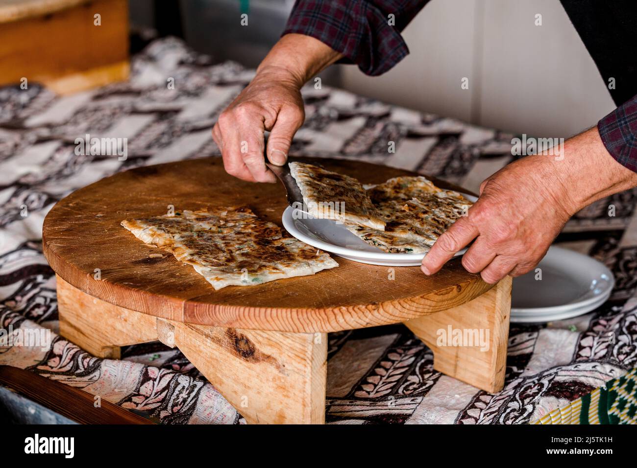 Preparing the cooked pancake for service by cutting it in Antalya ...