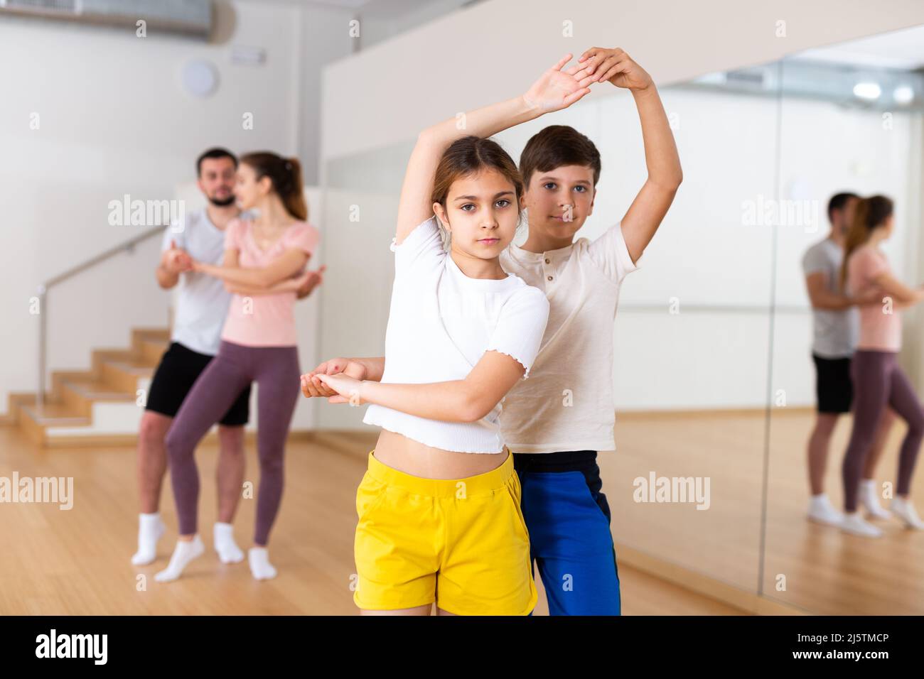 Teen sister and brother learning to dance waltz in pair in studio Stock ...