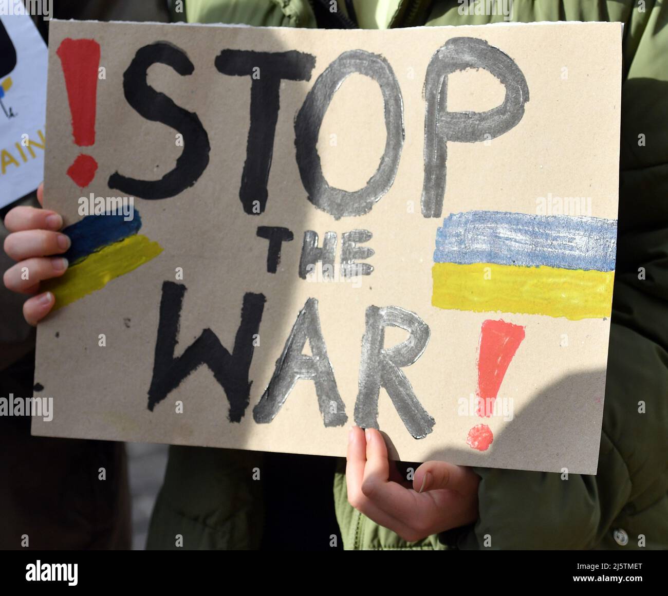 A demonstrator holds a placard with the words "stop the war" during the ...