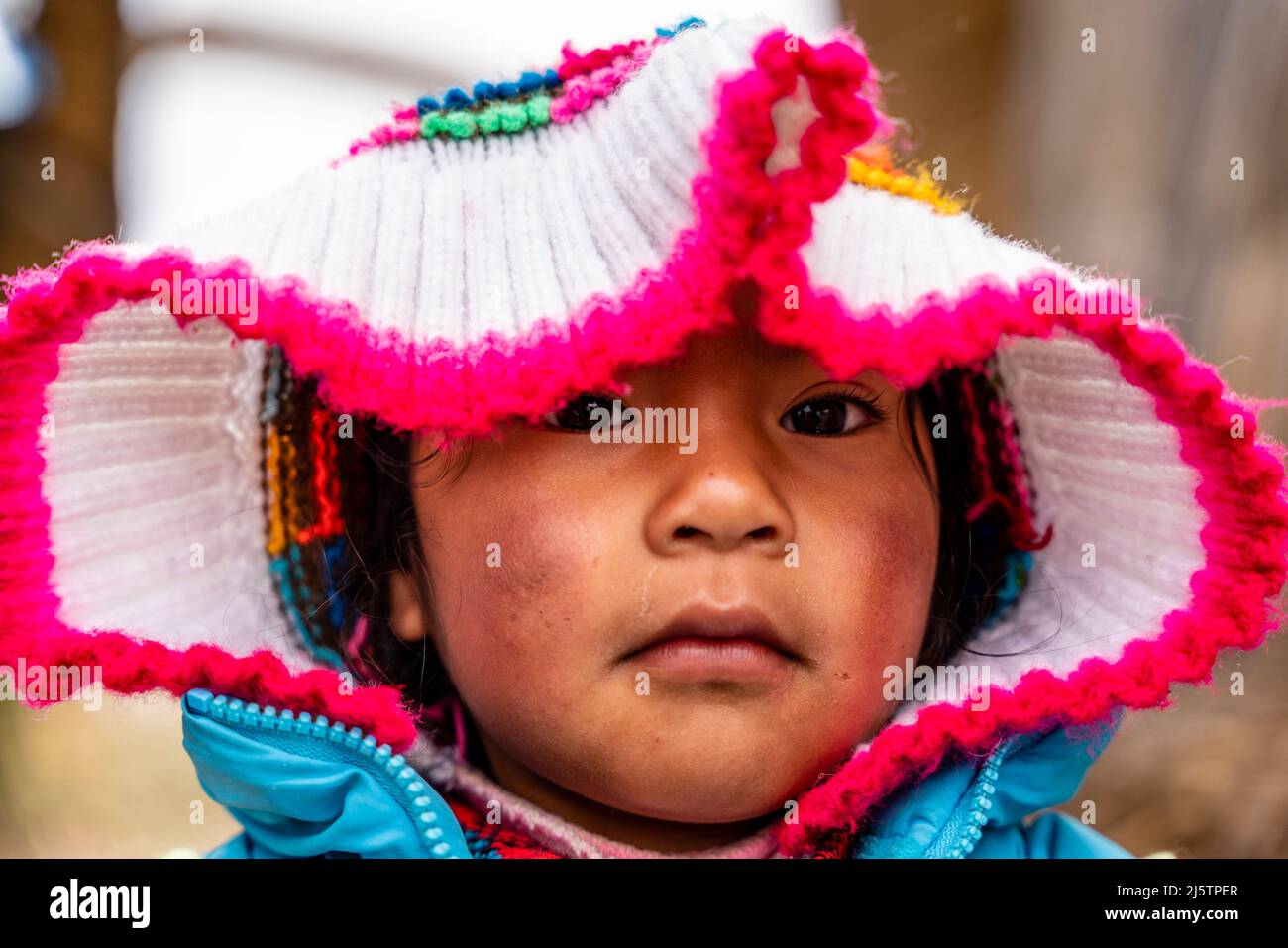An Uros Child On The Uros Floating Islands, Lake Titicaca, Puno, Peru ...