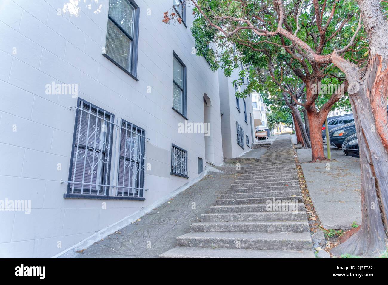 Concrete steps on a sloped side walk near the buildings in San ...
