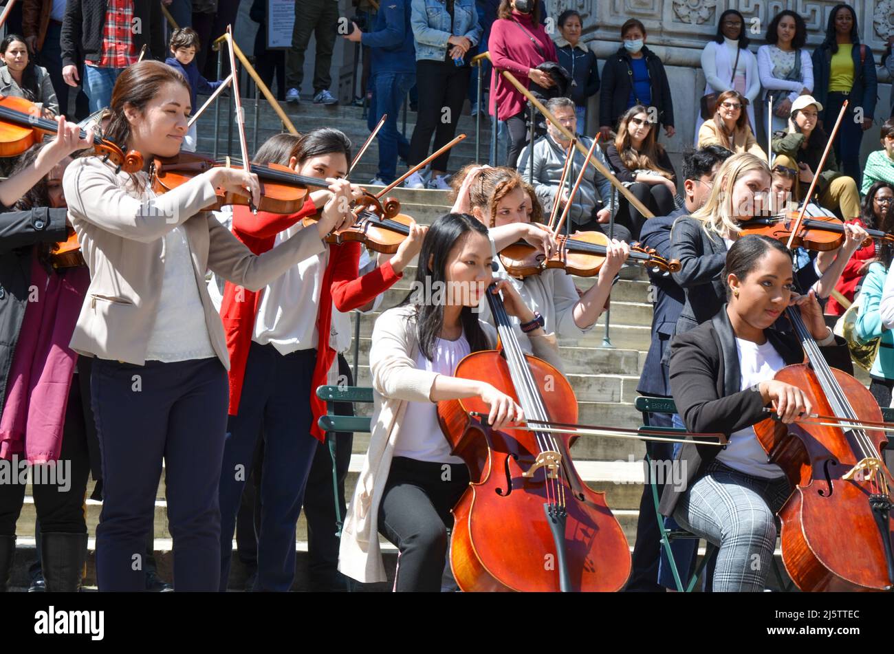 People are seen playing musical instruments in front of Mid-Manhattan ...