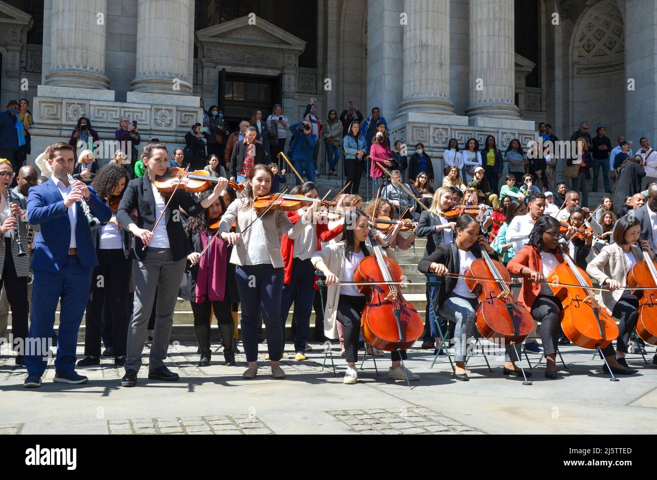 People are seen playing musical instruments in front of Mid-Manhattan ...