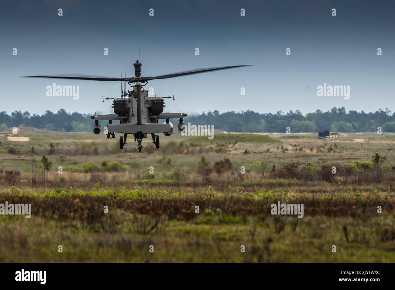 An AH-64E Apache helicopter hovers over the range during an aerial ...