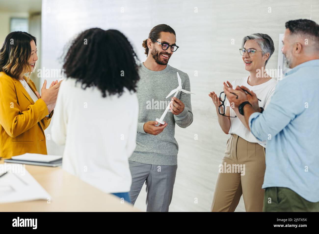 Happy design professionals applauding cheerfully during a meeting in a ...