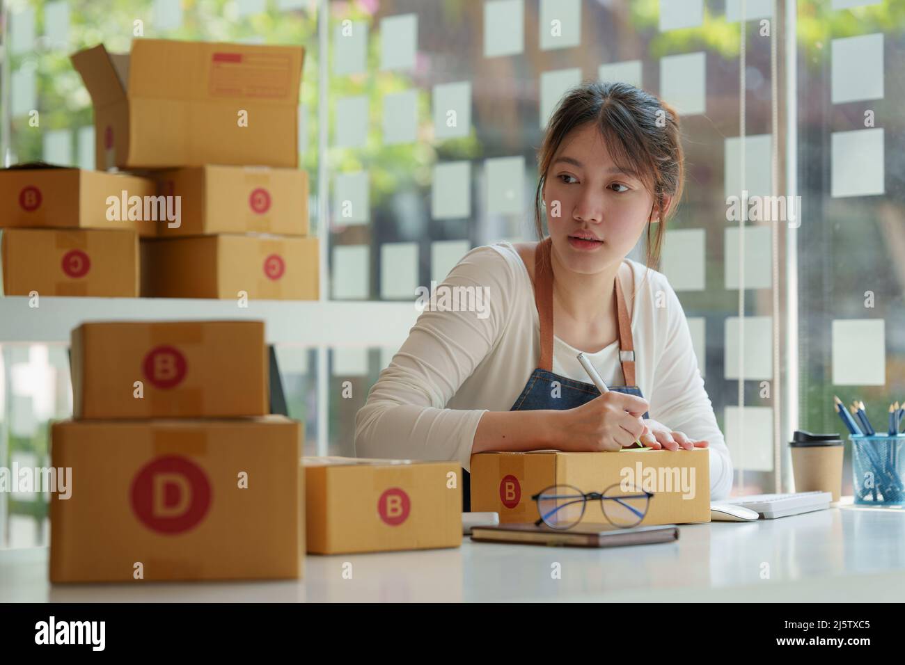 Asian small business owner with packing parcel box at home office, SME ...