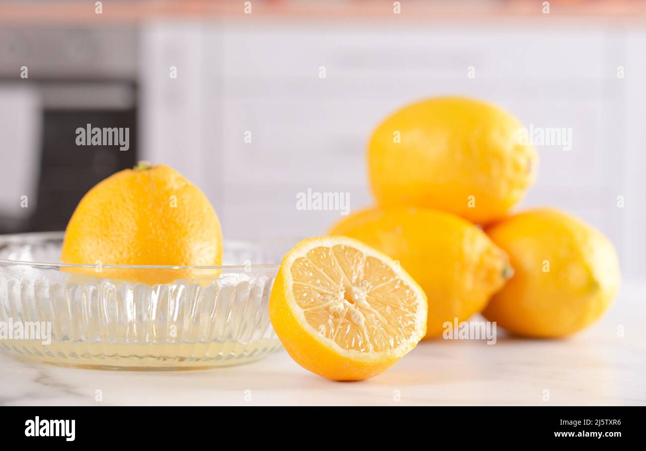 Lemon Being Juiced on a Marble Kitchen Counter Stock Photo - Alamy