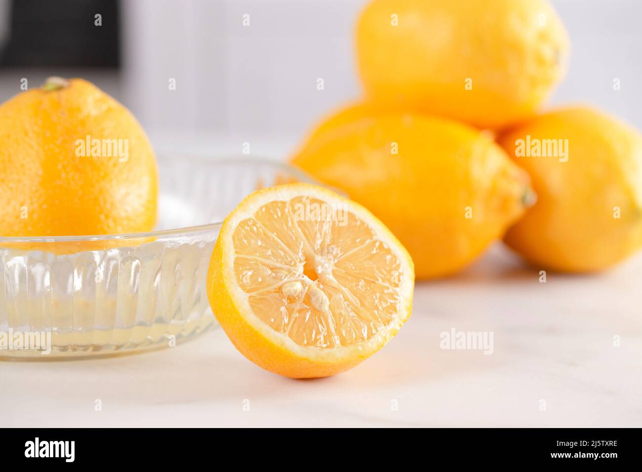 Lemon Being Juiced on a Marble Kitchen Counter Stock Photo - Alamy