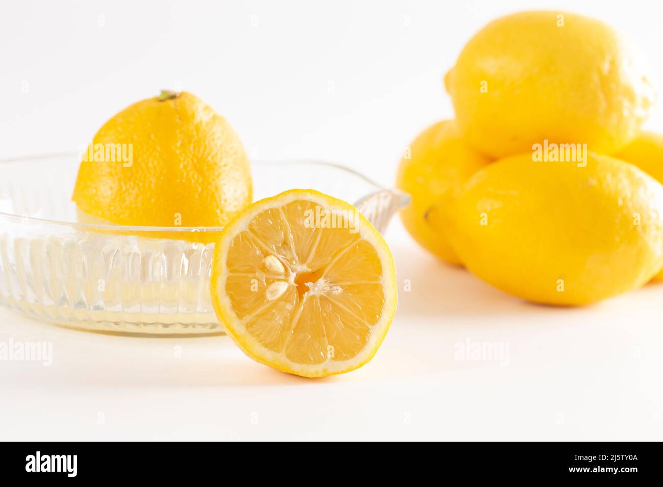 Lemon Being Juiced on a White Background Stock Photo - Alamy