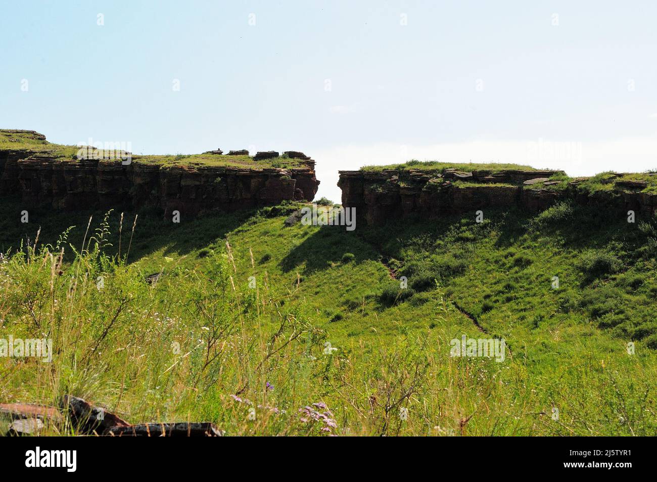 The remains of an ancient stone structure going along the top of a long ...
