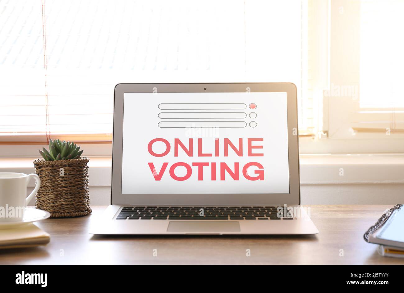 Laptop with text ONLINE VOTING on screen at workplace Stock Photo - Alamy