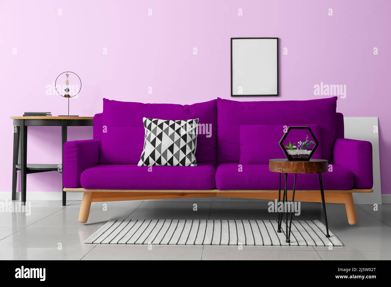 Interior of modern living room with bright sofa and tables Stock Photo ...