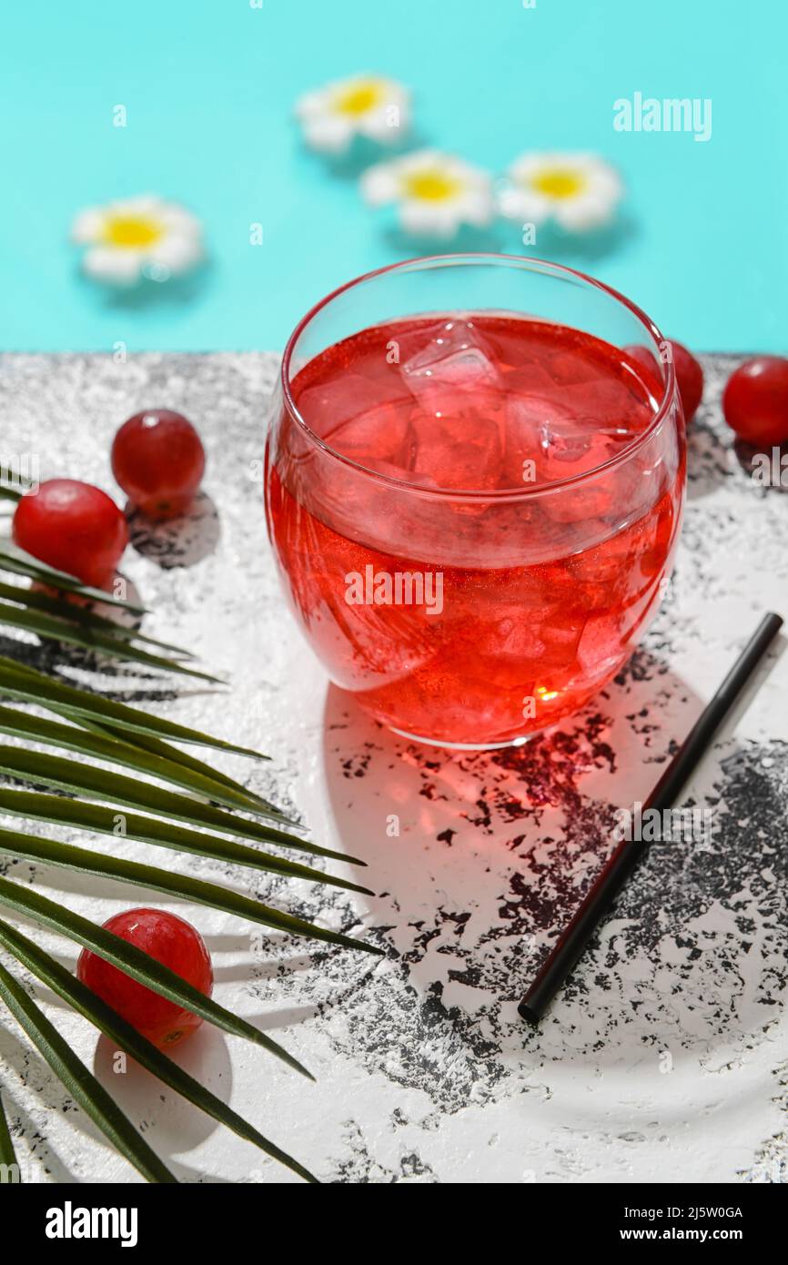 Glass of fresh grape soda on edge of swimming pool, closeup Stock Photo ...