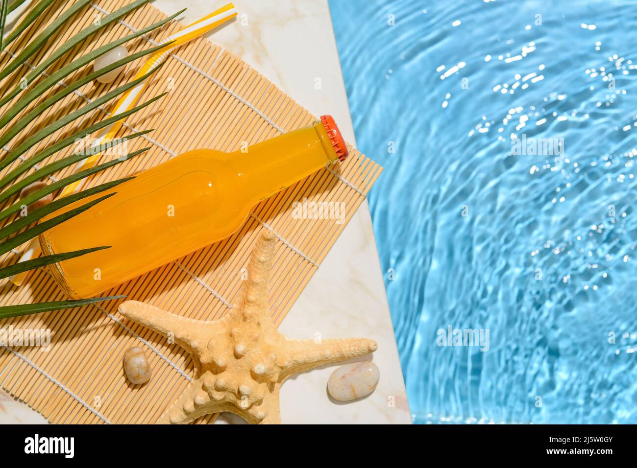 Bottle of fresh soda on edge of swimming pool Stock Photo - Alamy