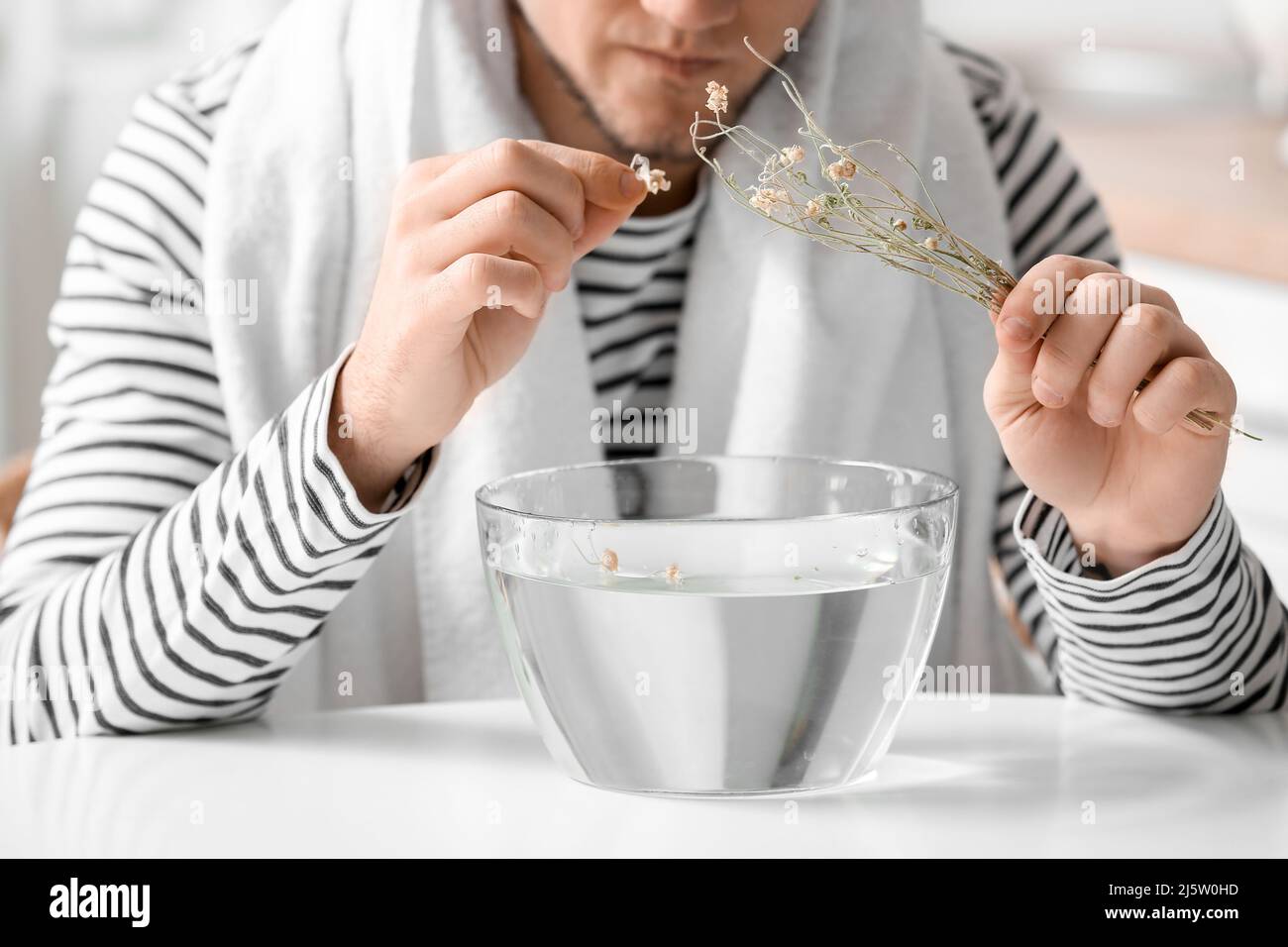 Young man doing steam inhalation at home to soothe and open nasal ...