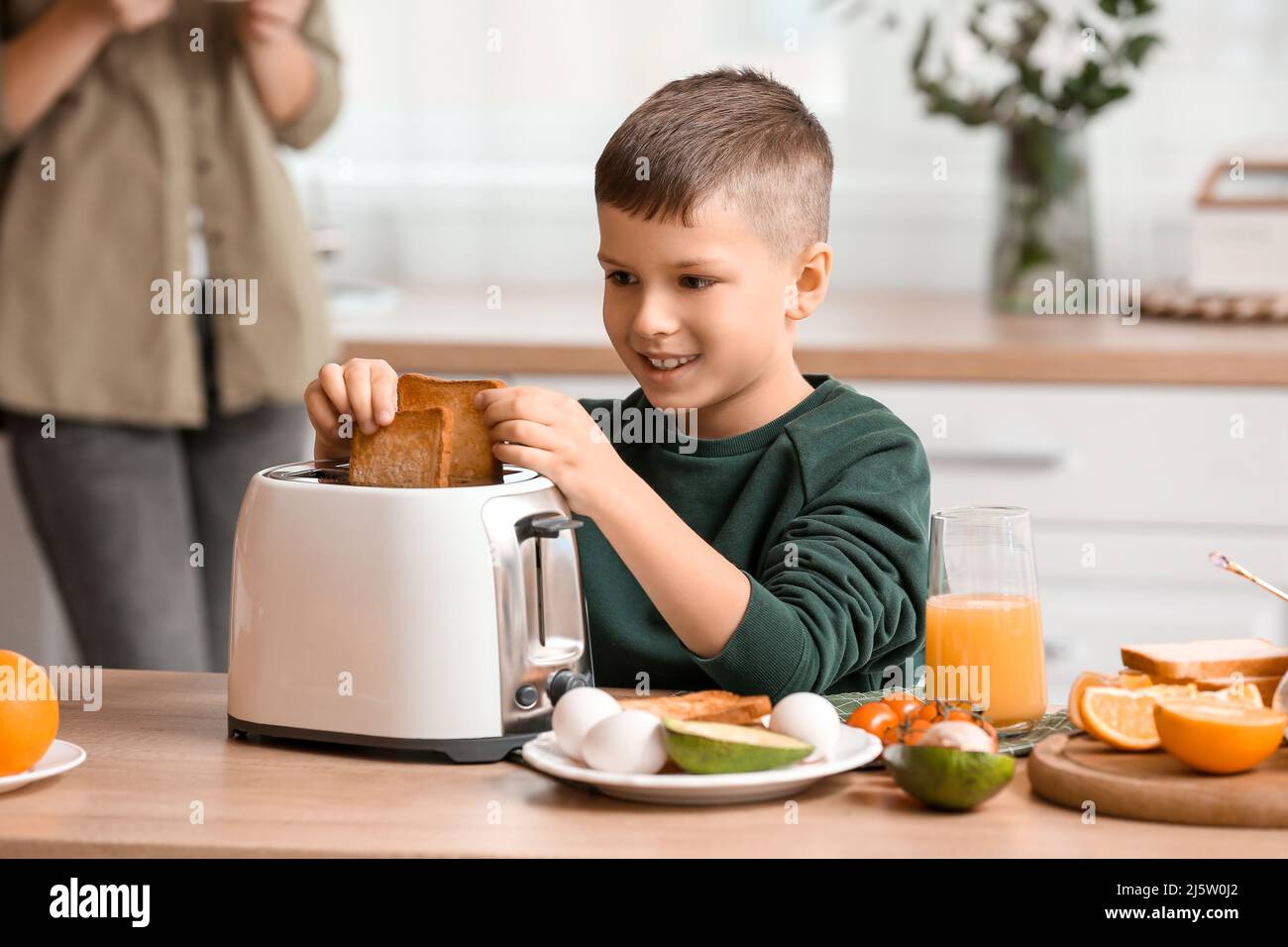 Little boy making tasty toasts in kitchen Stock Photo - Alamy