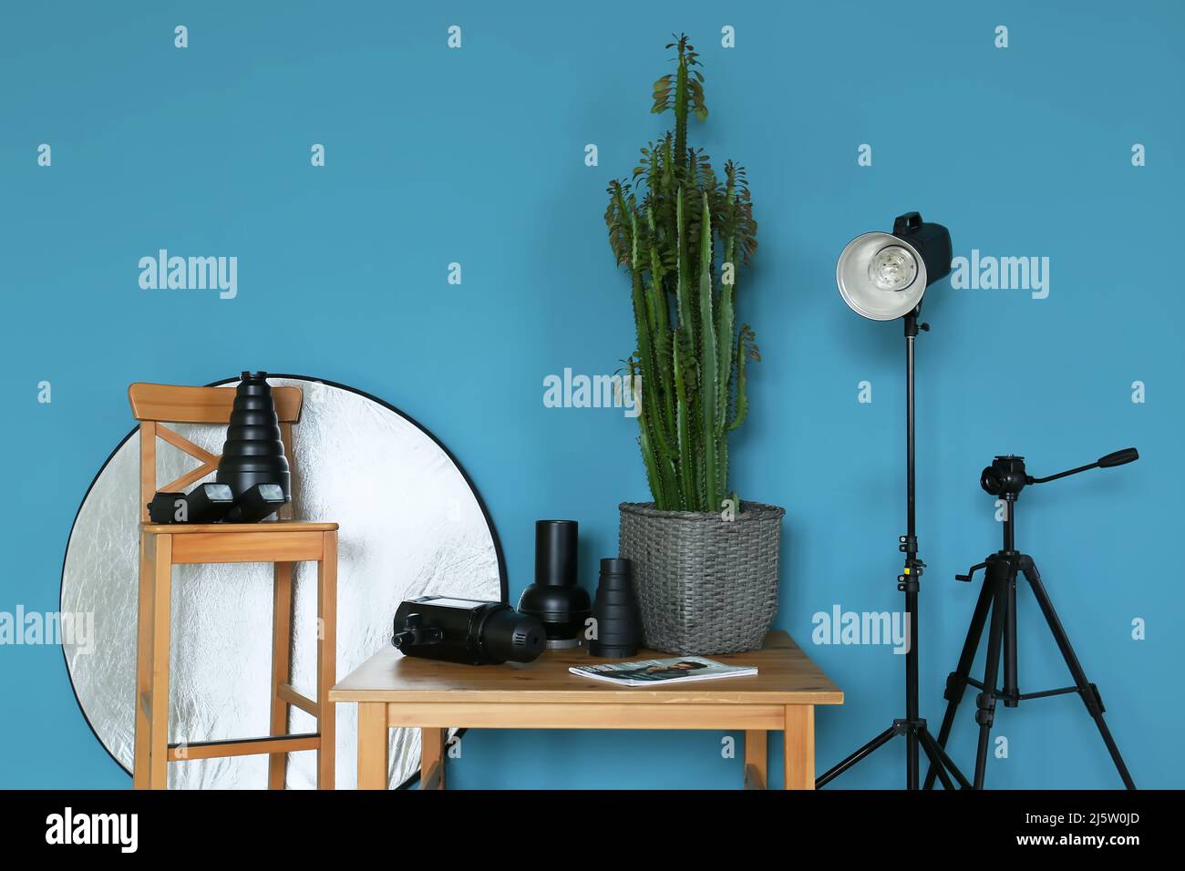 Wooden table and chair with different equipment for photo studio near ...