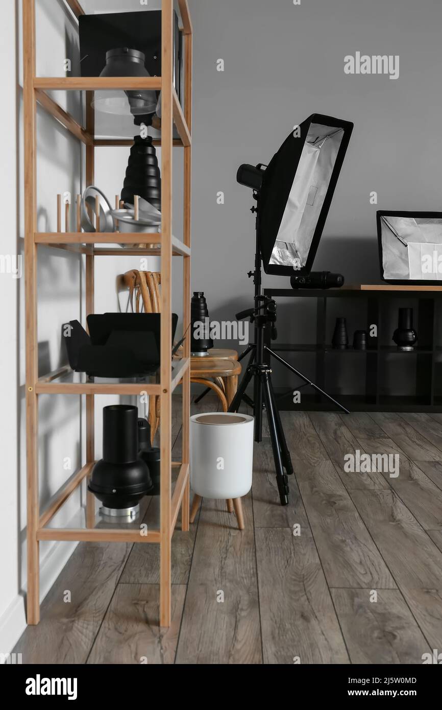 Shelf unit with different professional equipment in stylish photo ...