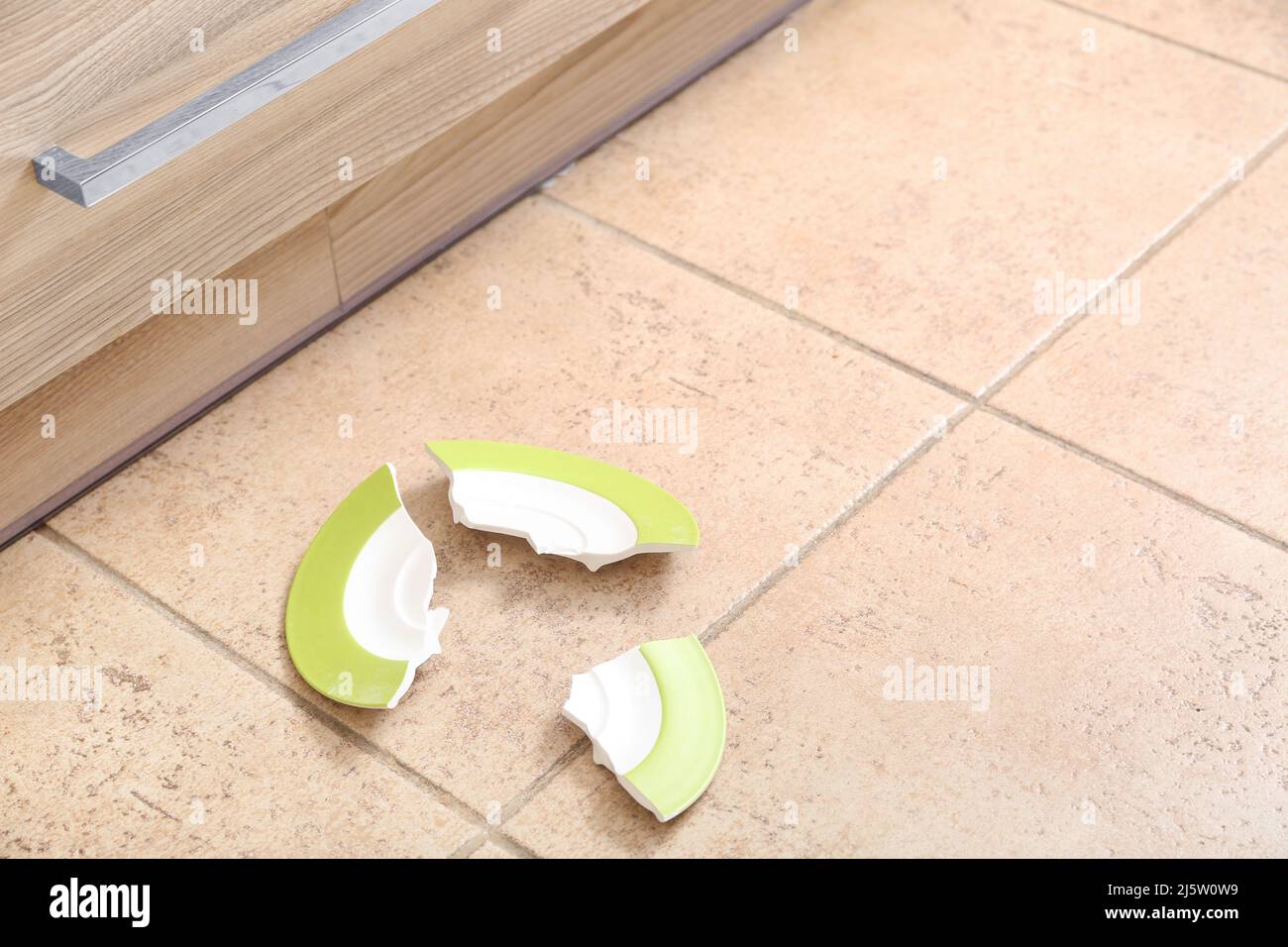 Pieces of broken ceramic plate on floor Stock Photo - Alamy