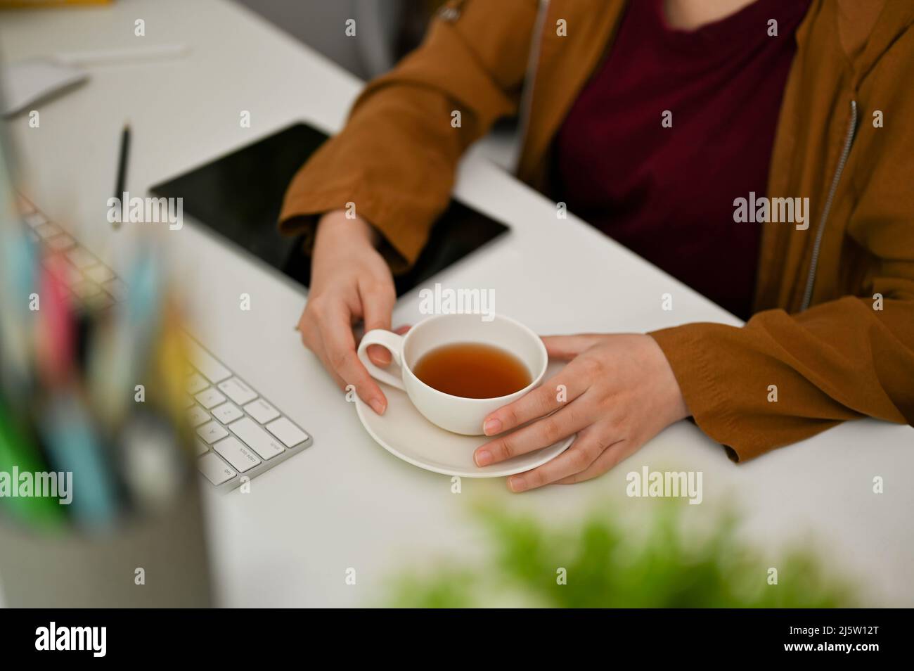 Female worker or graphic designer sitting at her office desk, having an ...