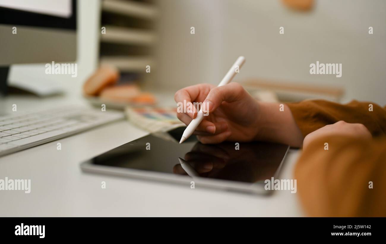Close-up and focused hand, Female or graphic designer using stylus pen ...