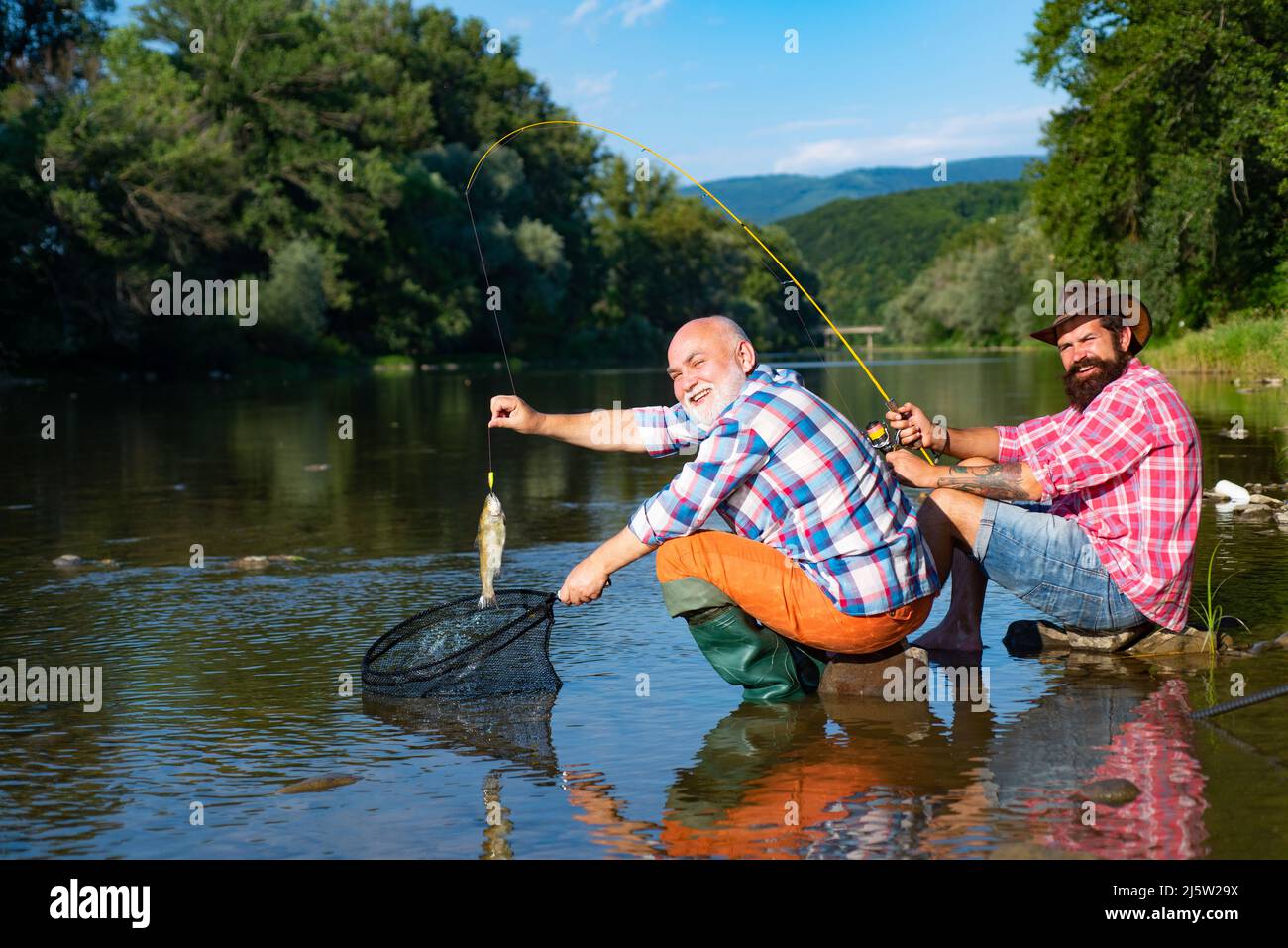 Senior man young man riverside hi-res stock photography and images - Alamy