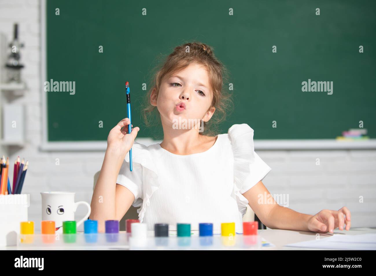 Child girl drawing with coloring pens paintind. Portrait of adorable ...