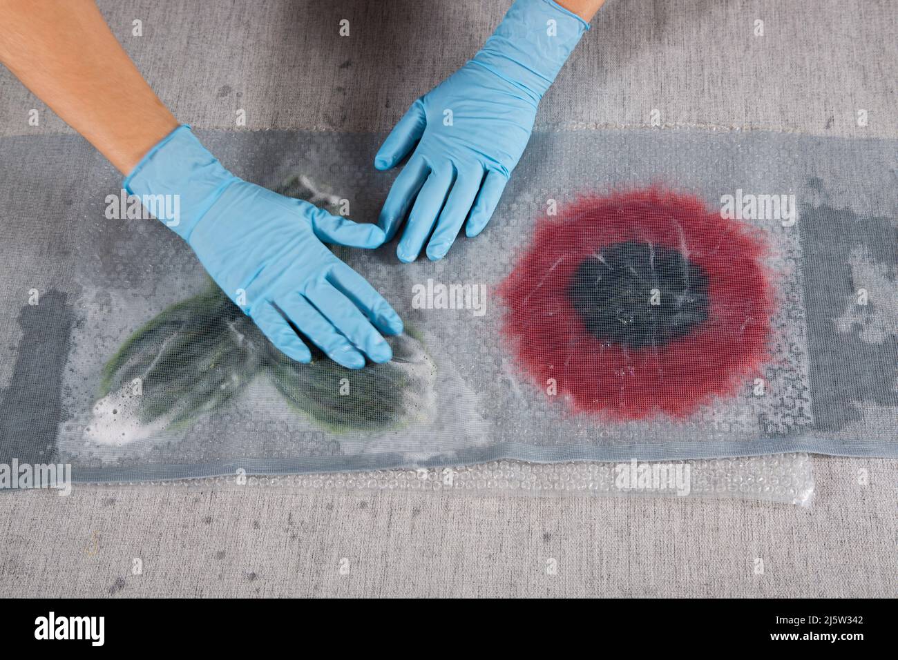 Wet felting wool in the process of creating a product Stock Photo - Alamy