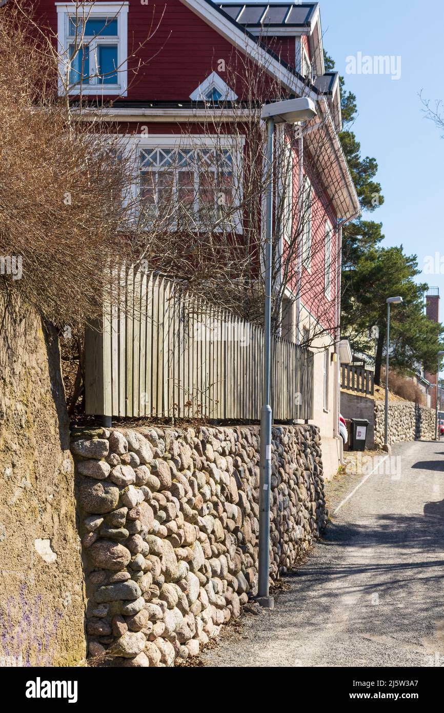 Old buildings and a stone wall by the Provastinkatu street in Pispala ...
