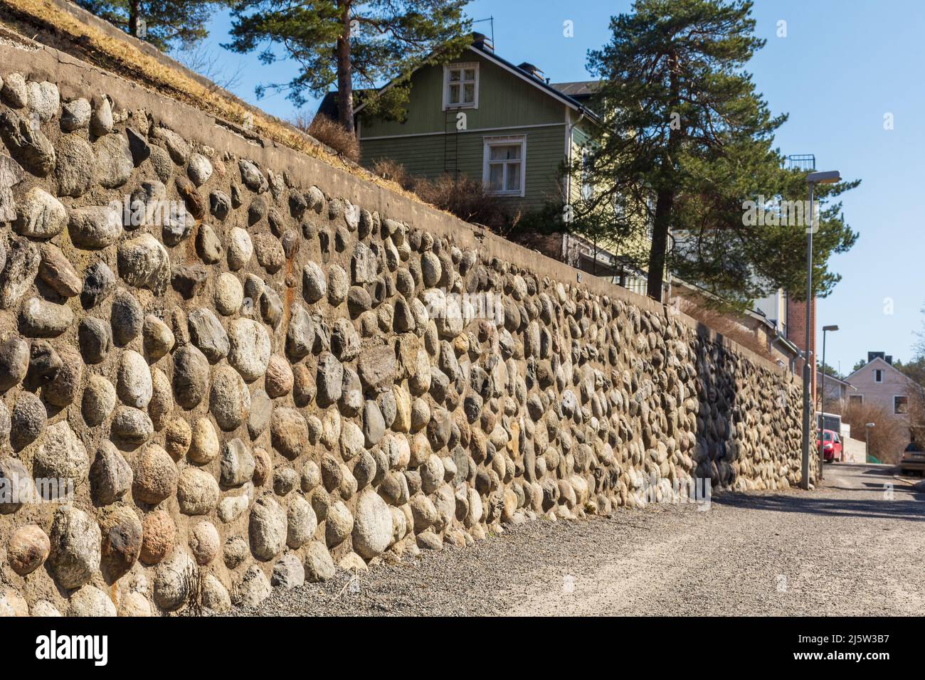 Old buildings and a stone wall by the Provastinkatu street in Pispala ...