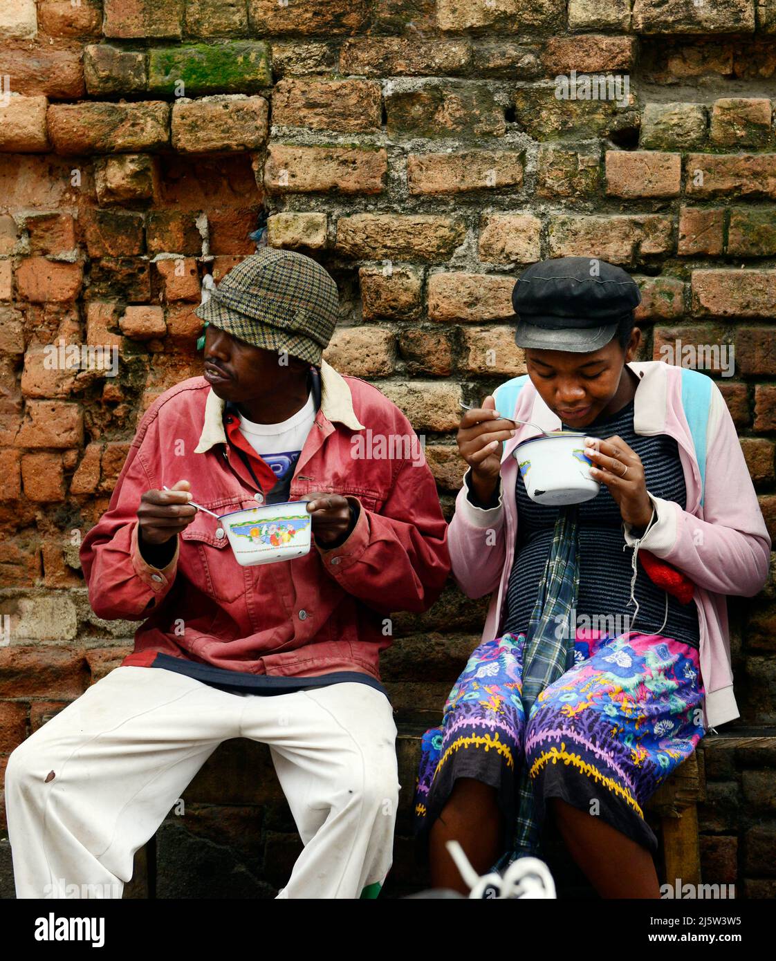 A Malagasy couple eating lunch on the street. Antananarivo, Madagascar ...