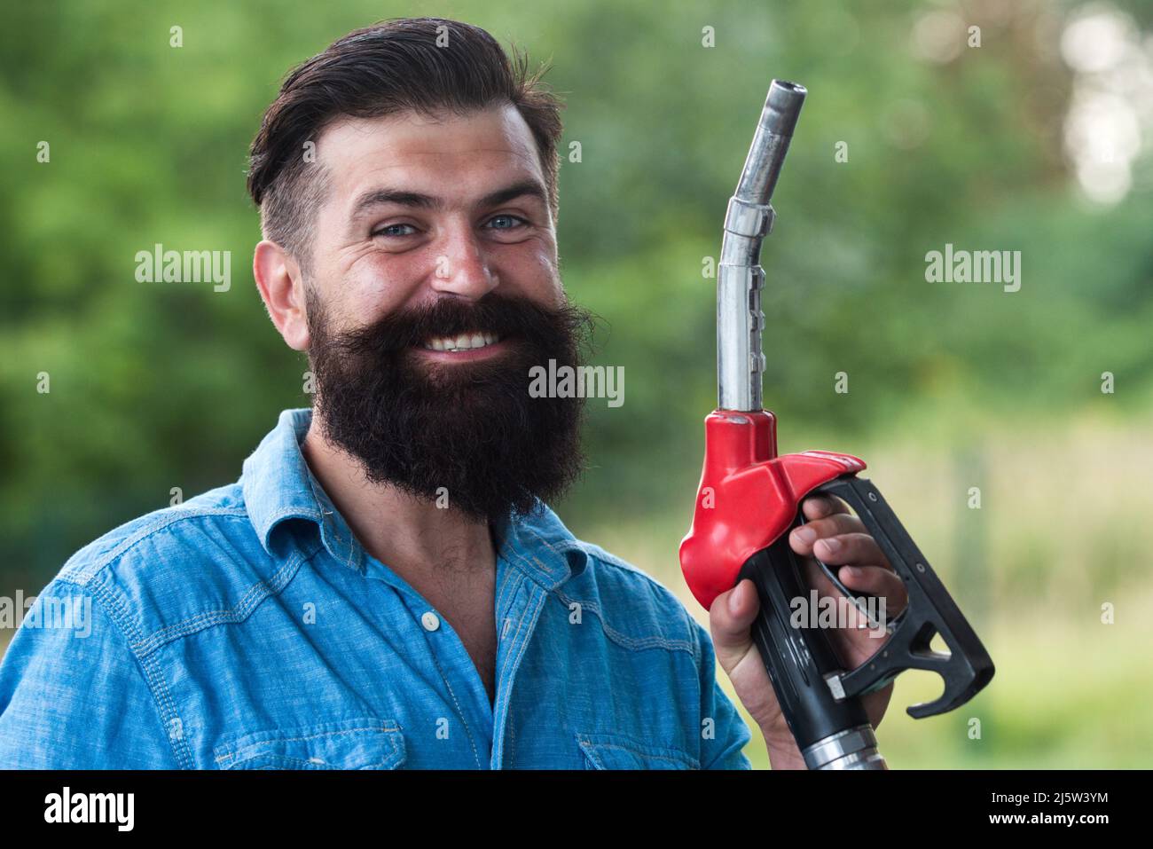 Man fueling his car at a self service petroleum gas station hi-res ...