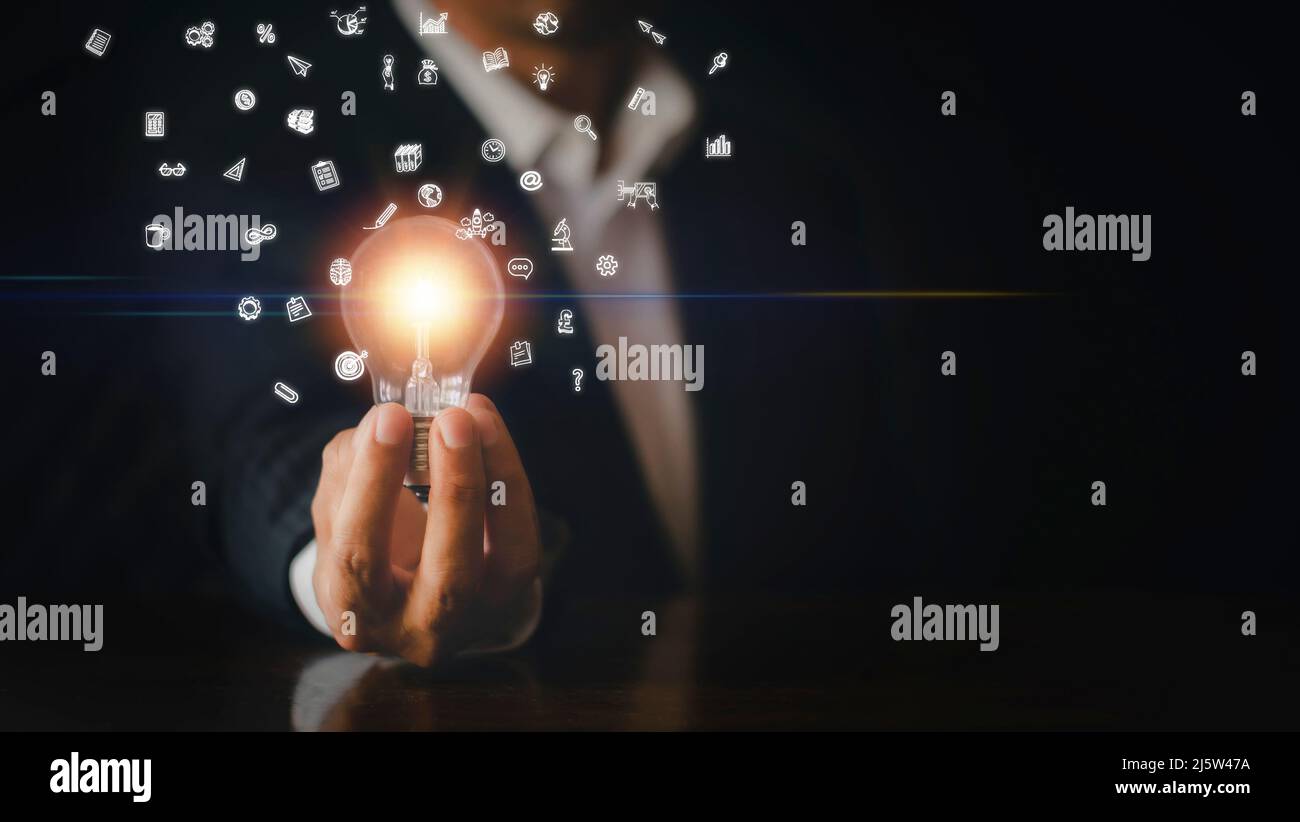 Business man hand hold light bulb with drawing with circuit of network ...