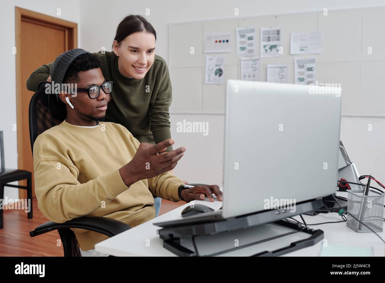 Young African American male programmer making presentation of decoded ...