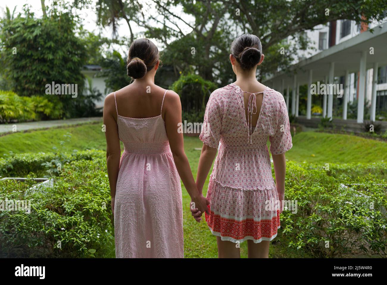 Multiracial women holding hands hi-res stock photography and images - Alamy