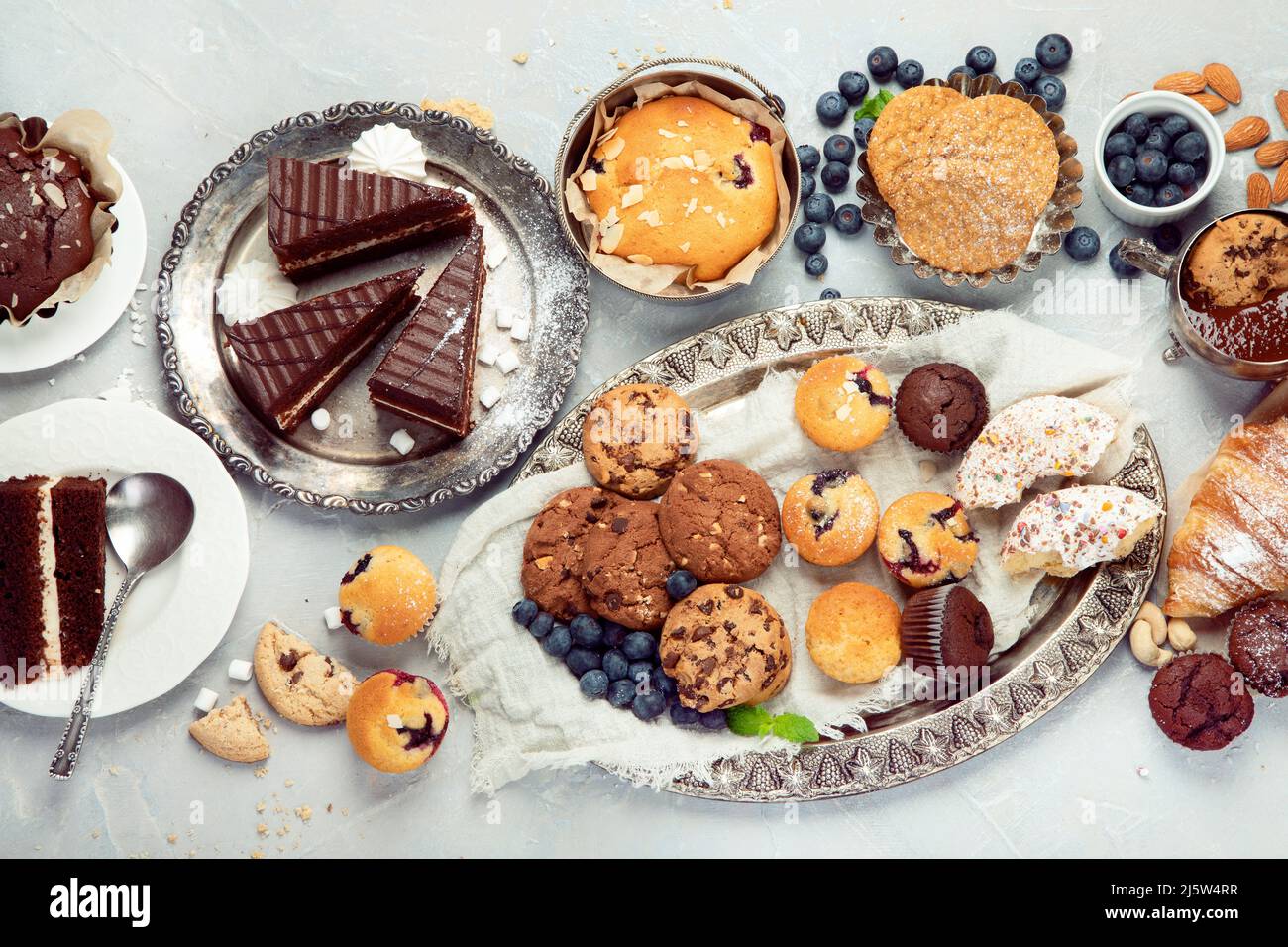 Dessert table with all kinds snacks on light background. Candy bar ...