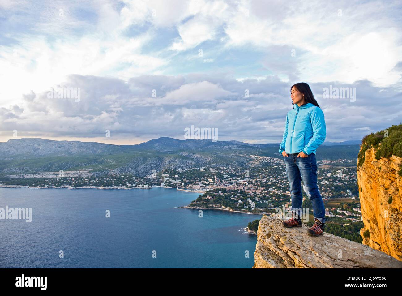 woman standing on top of a cliff at the French Cote d'Azur Stock Photo ...