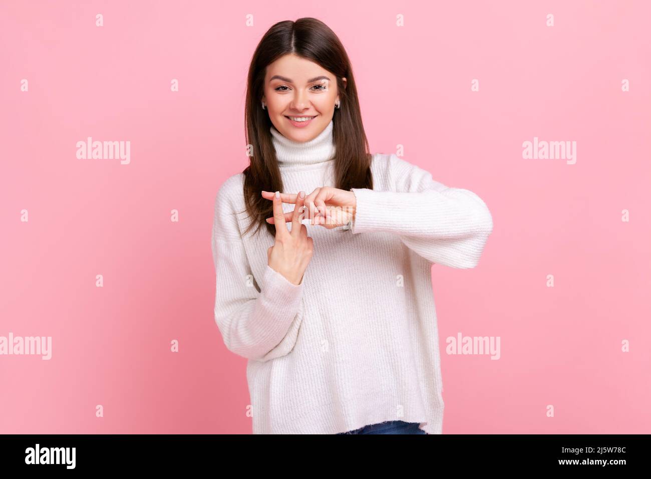 Positive popular woman blogger making hashtag sign with fingers ...