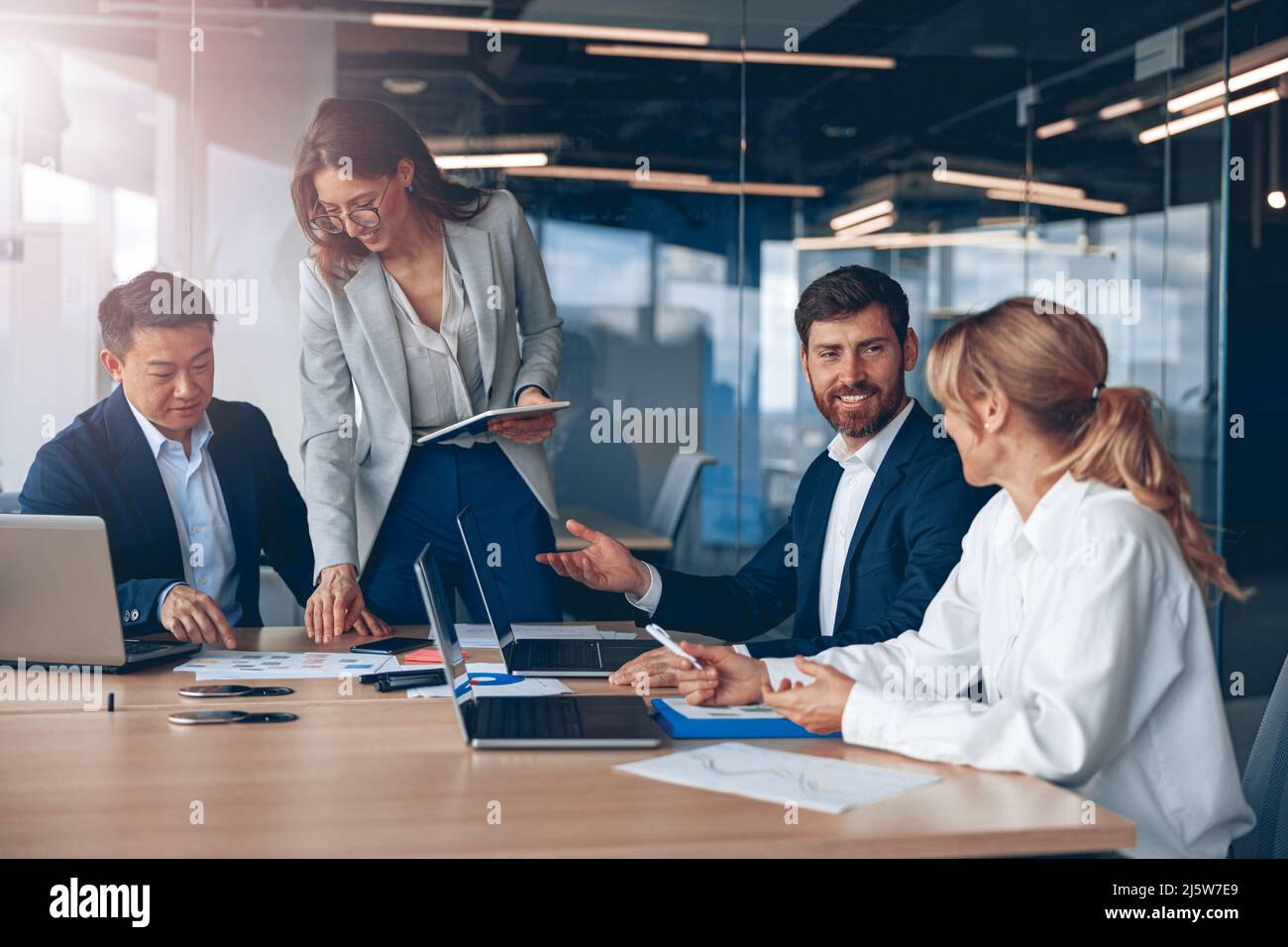 Woman explaining her ideas to colleagues in conference room at modern ...