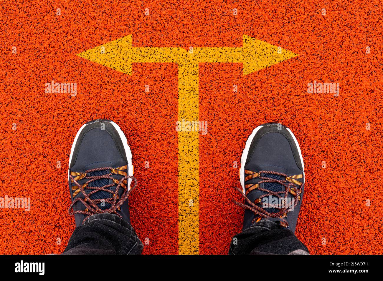 Go left or right. A man standing on the road thinking about choices ...