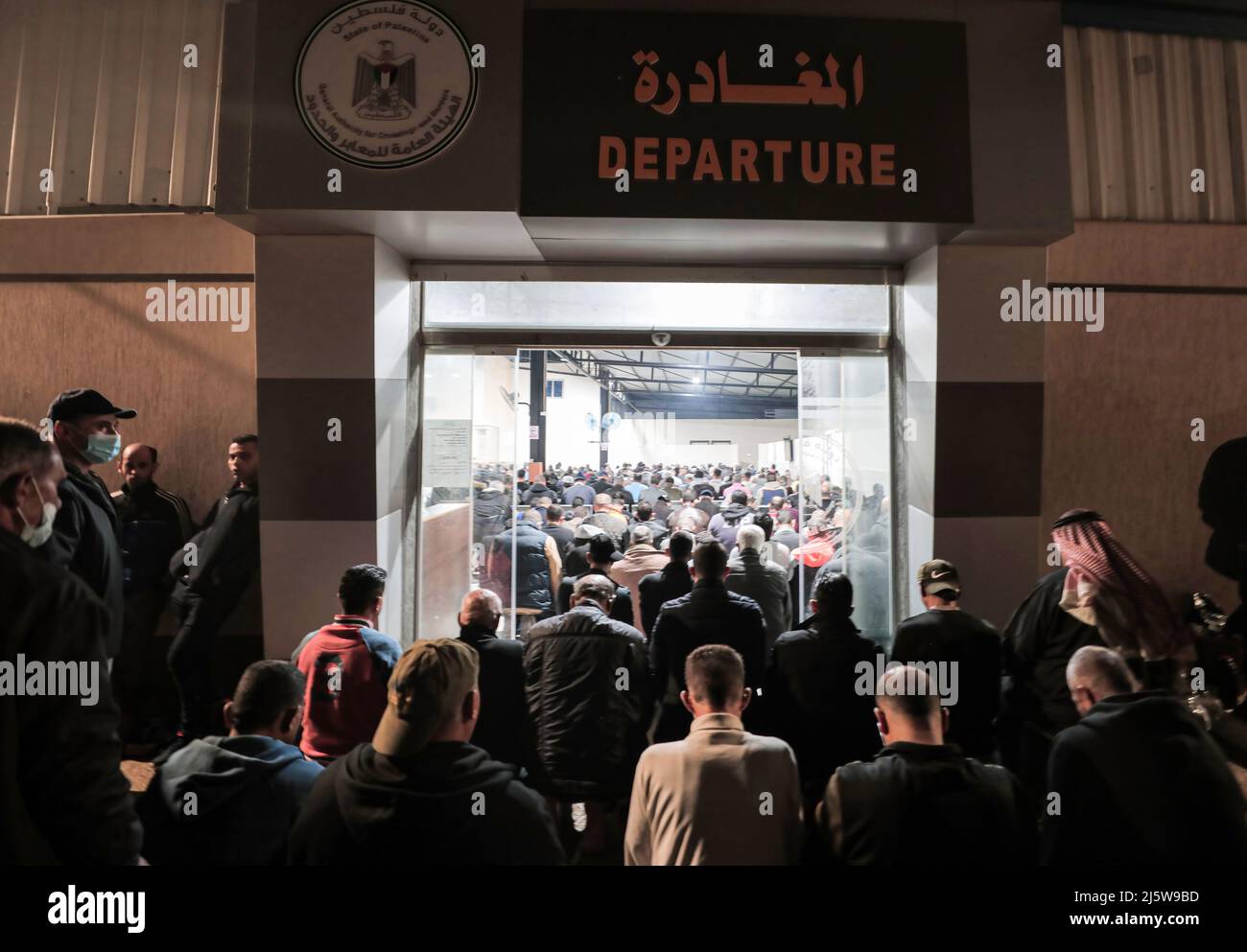 Palestinian workers pray at the Erez crossing between the Gaza Strip ...