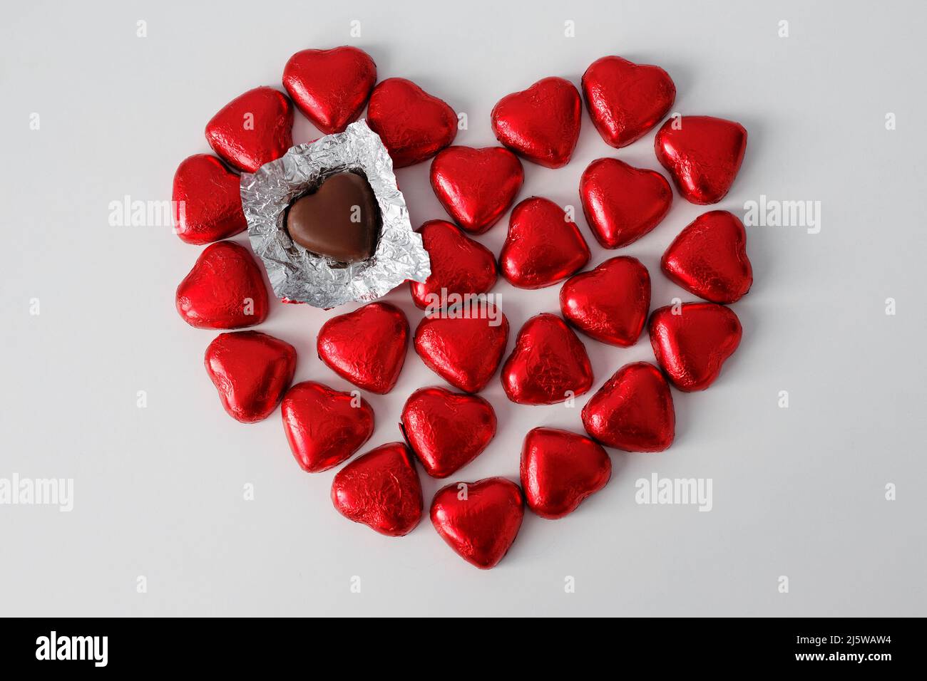 Love and broken haert concept - heart shape chocolate candies wrapped ...